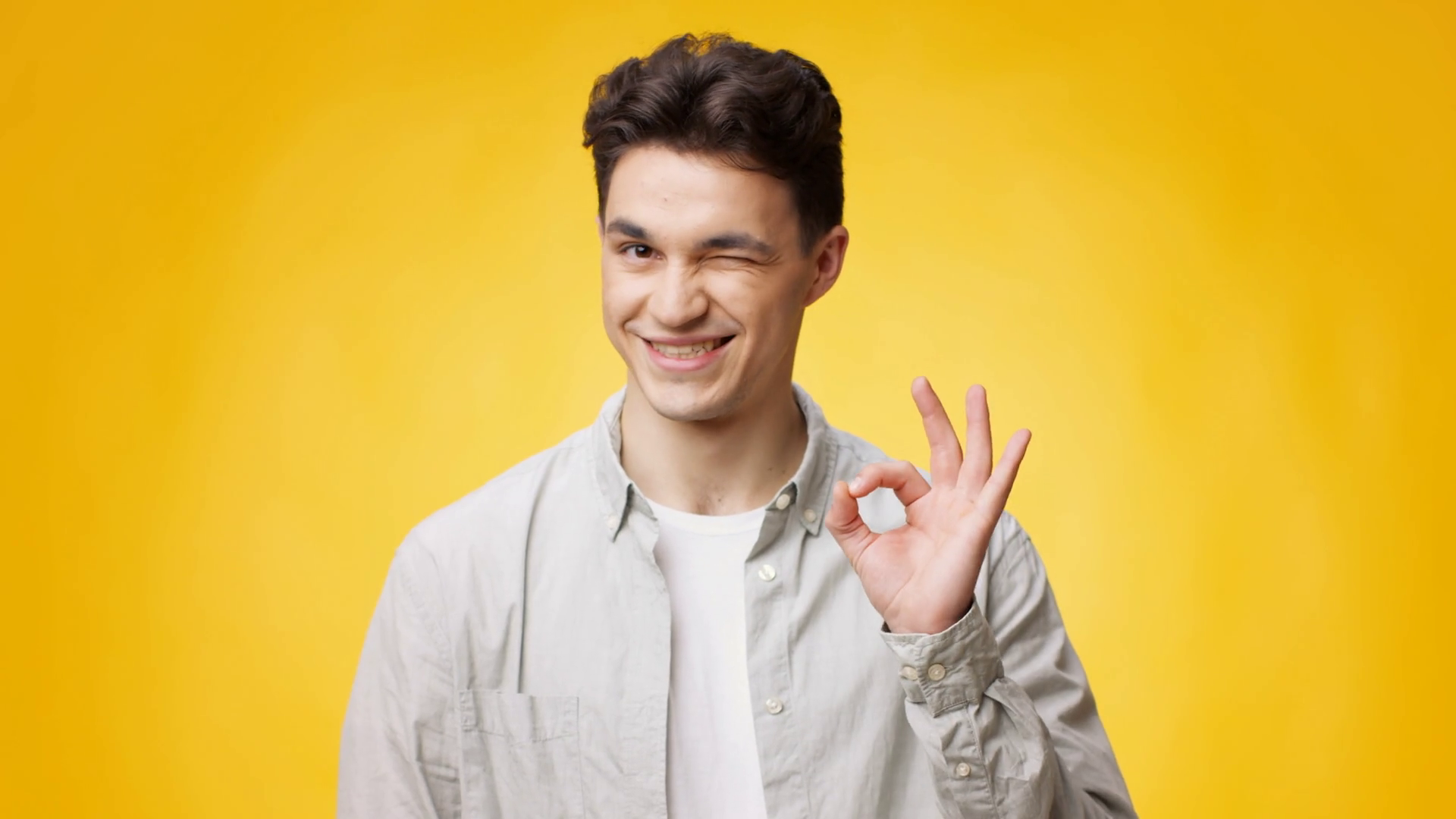 A Young Man Stands Confidently Gesturing Ok Stock Footage SBV-351826040 ...