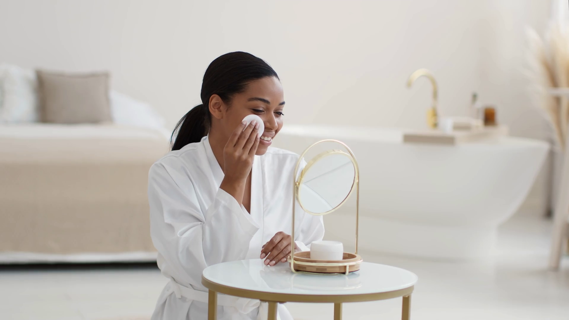 Skin cleansing. Young happy african american lady cleaning her face ...