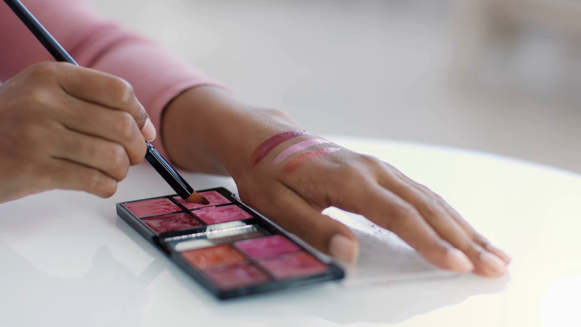 Make up testing. Close up of female hand with smears, unrecognizable ...