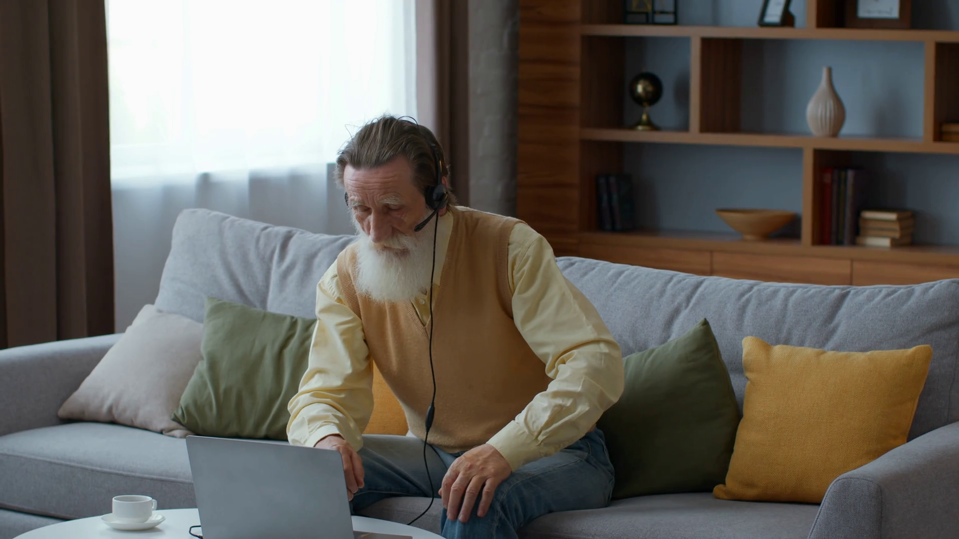 Remote work for old people. Senior bearded man freelancer in headset ...