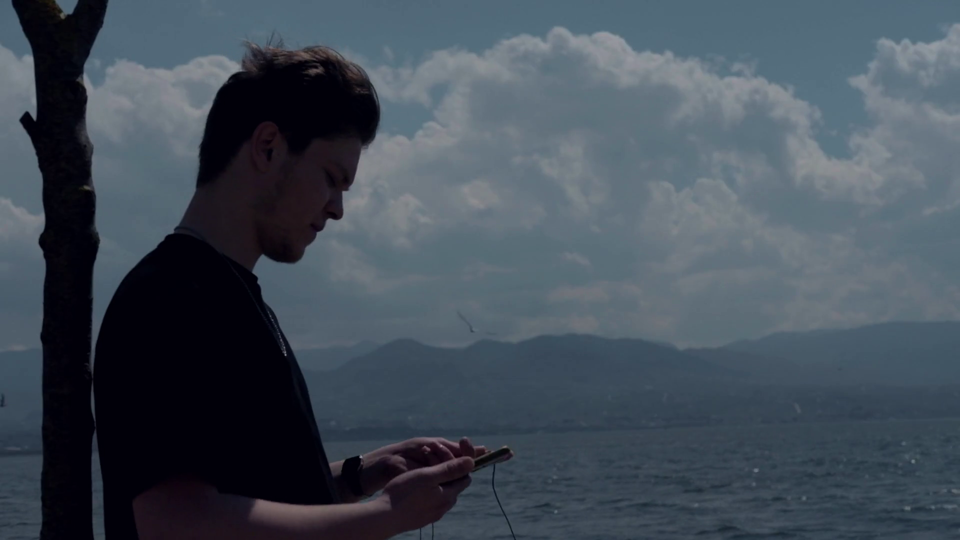 Young Man Alone At Sea Leaning Back Against Stock Footage SBV-347675381 ...