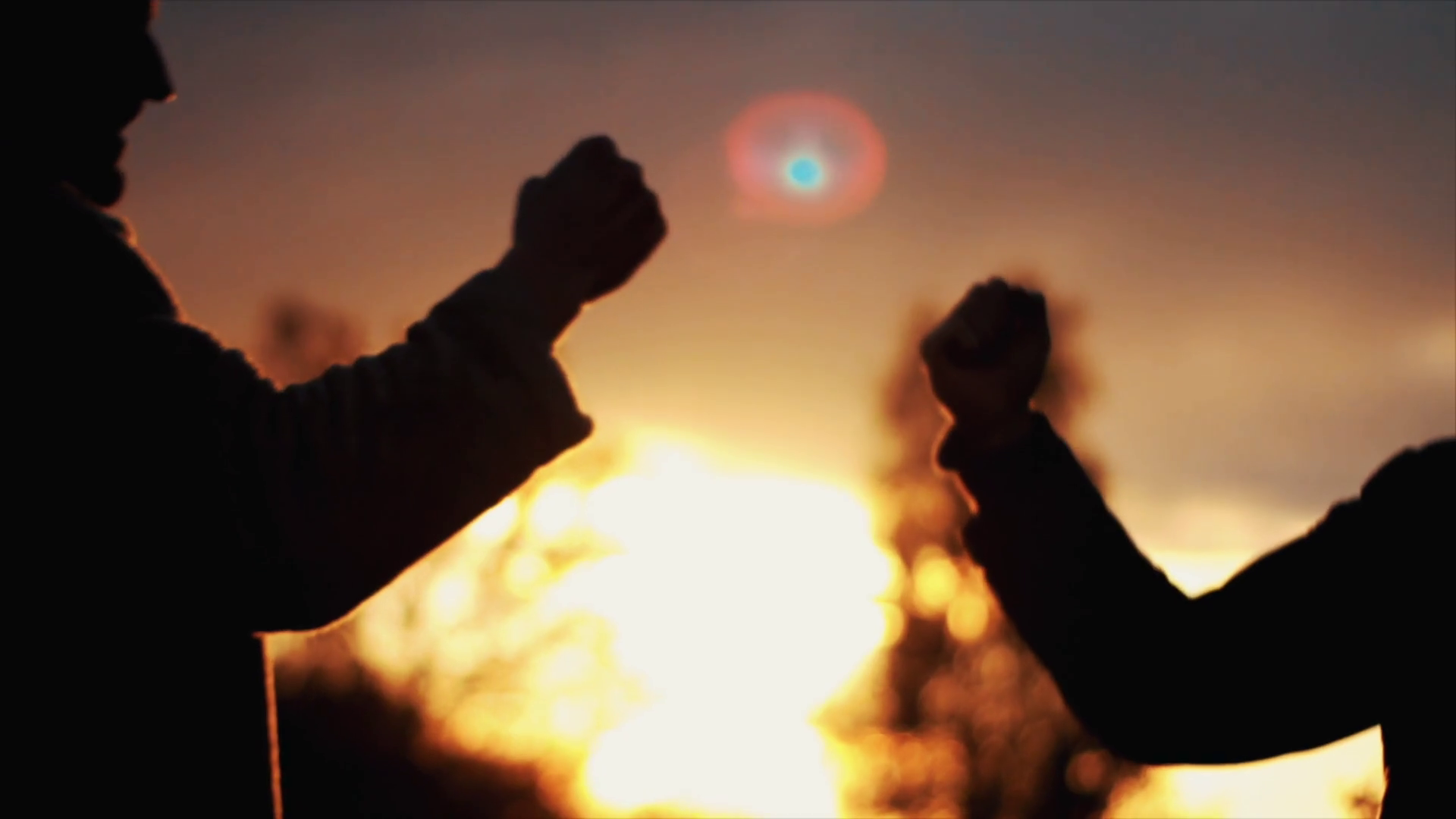 Silhouettes of two men playing rock paper scissors. Beautiful sunset ...