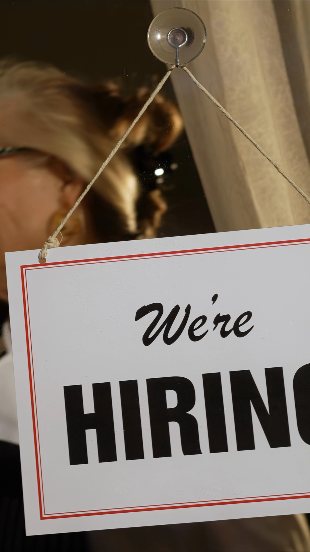 Female Shop Owner Putting Help Wanted Sign Stock Footage SBV-353174989 ...