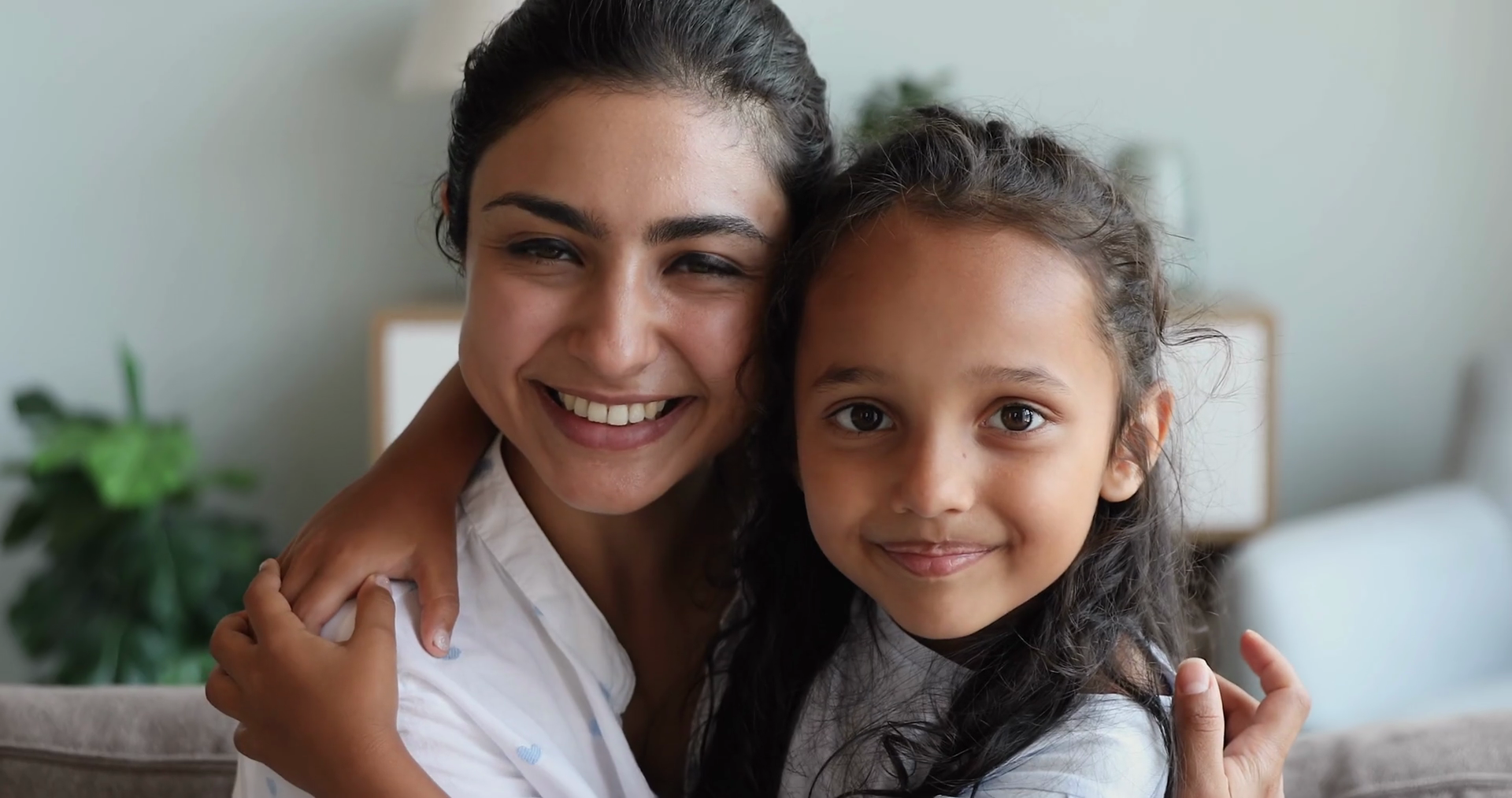 Happy smiling faces of cuddling Indian mother junior schoolgirl ...