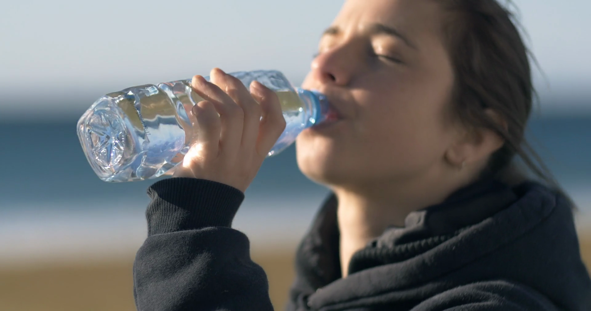 Girl drinking fresh natural water from a plastic bottle Stock Video ...