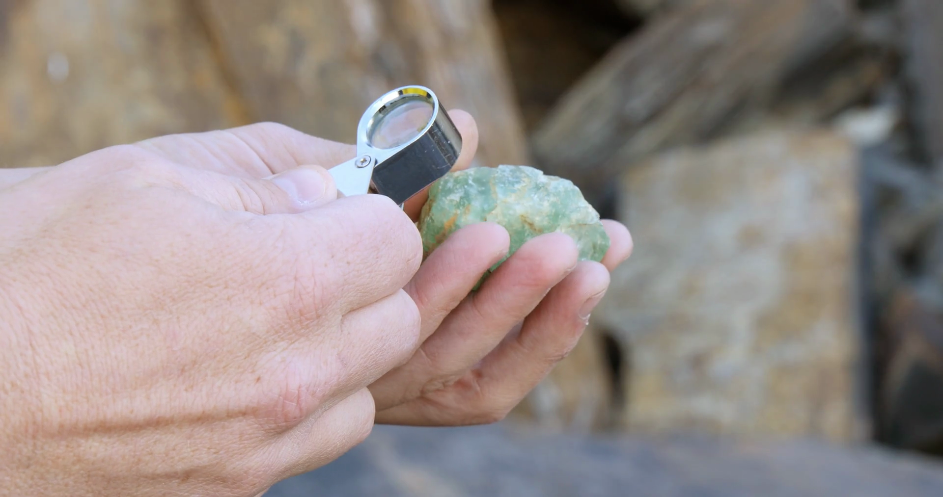 Close up look at mineral fluorite with loope hand lens mining ...