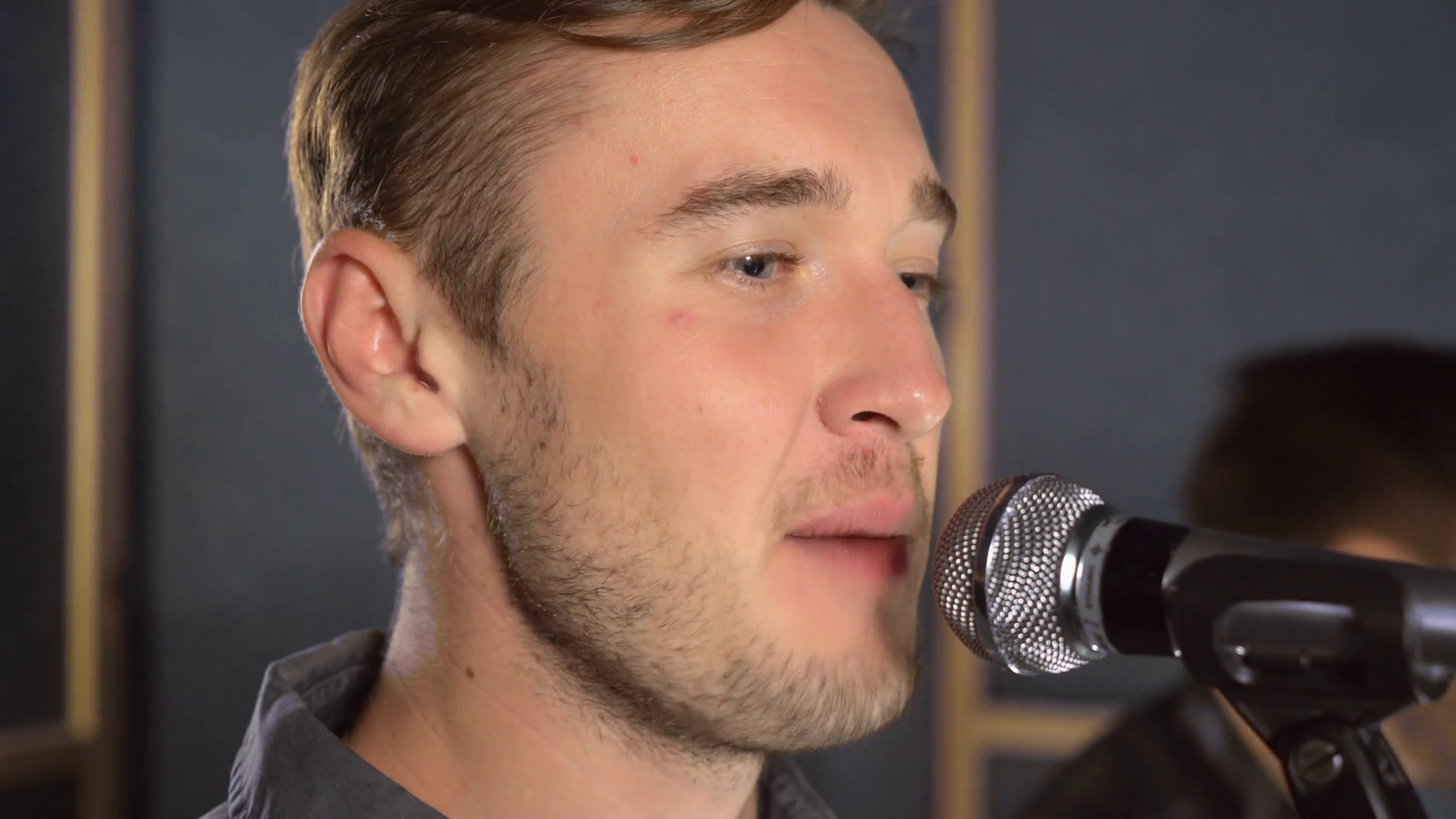 Portrait caucasian singer standing in front of microphone. Happy ...