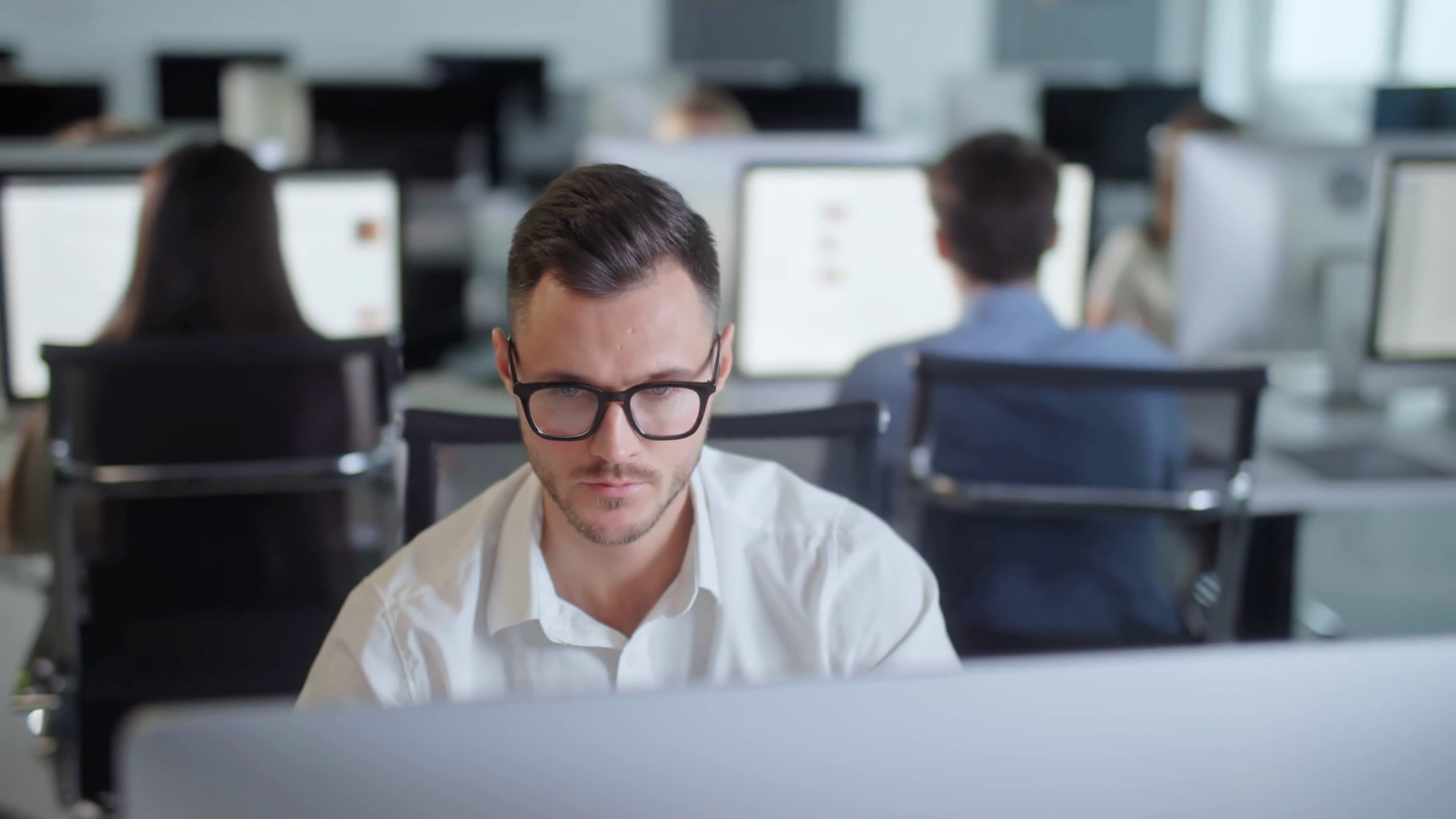 Serious Young Man Working on Decktop Computer While Working in Big Open ...