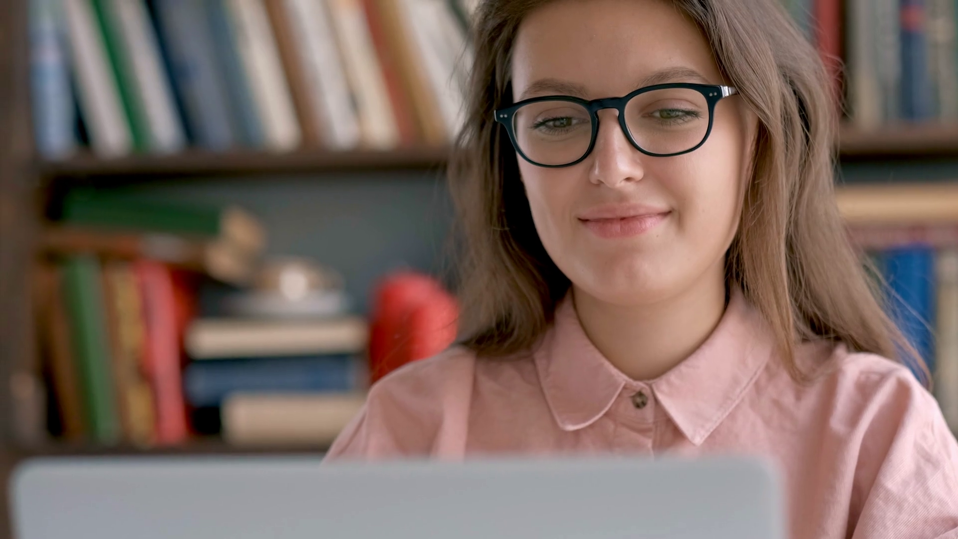 Female Student Sitting Against Bookshelf Stock Footage SBV-328571538 ...