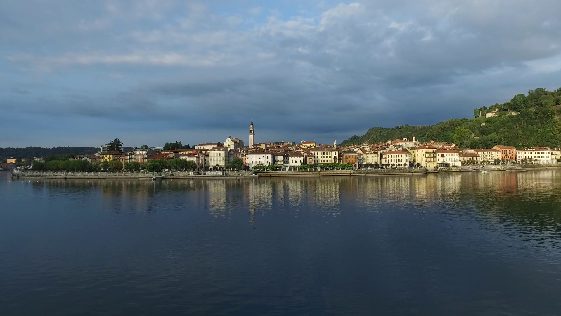 Aerial shot along a tropical beach in Italy Arona island morning sky ...