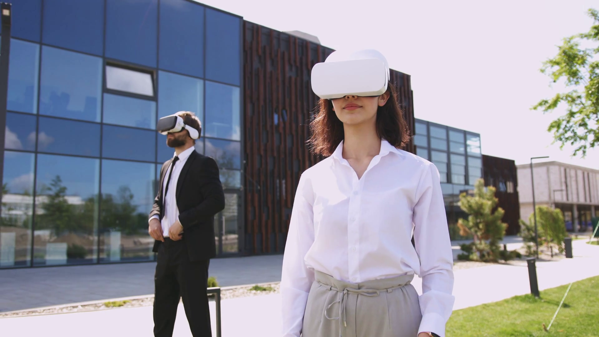 Caucasian man and woman in business style and VR headset standing ...