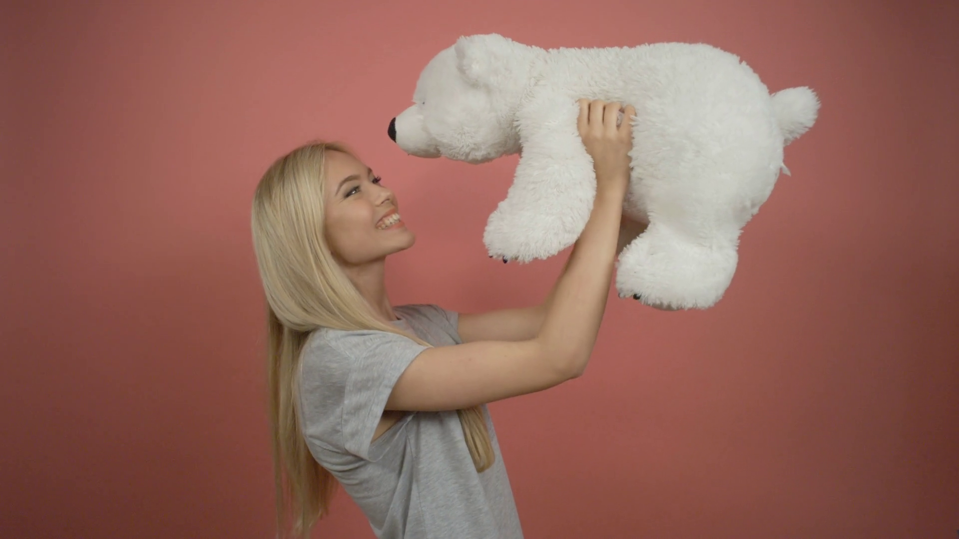 Positive Blonde Embracing Teddy Bear On Pink Stock Footage SBV ...