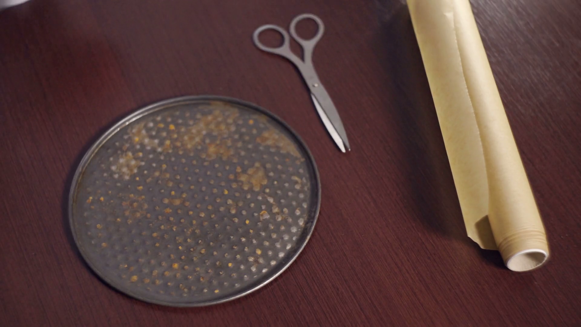 Cook Cutting A Section Of Greaseproof Paper With Scissors Cutting cook-cutting-a-section-of-greaseproof-paper-with-scissors-cutting