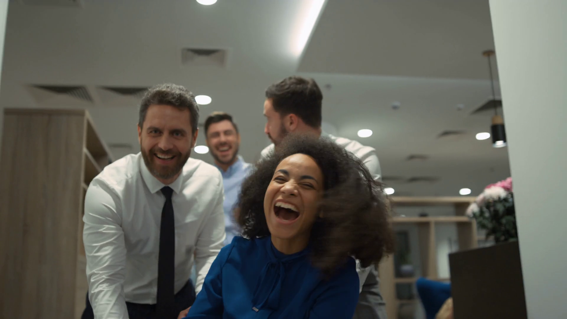 Management team racing office chair celebrating work break in company ...