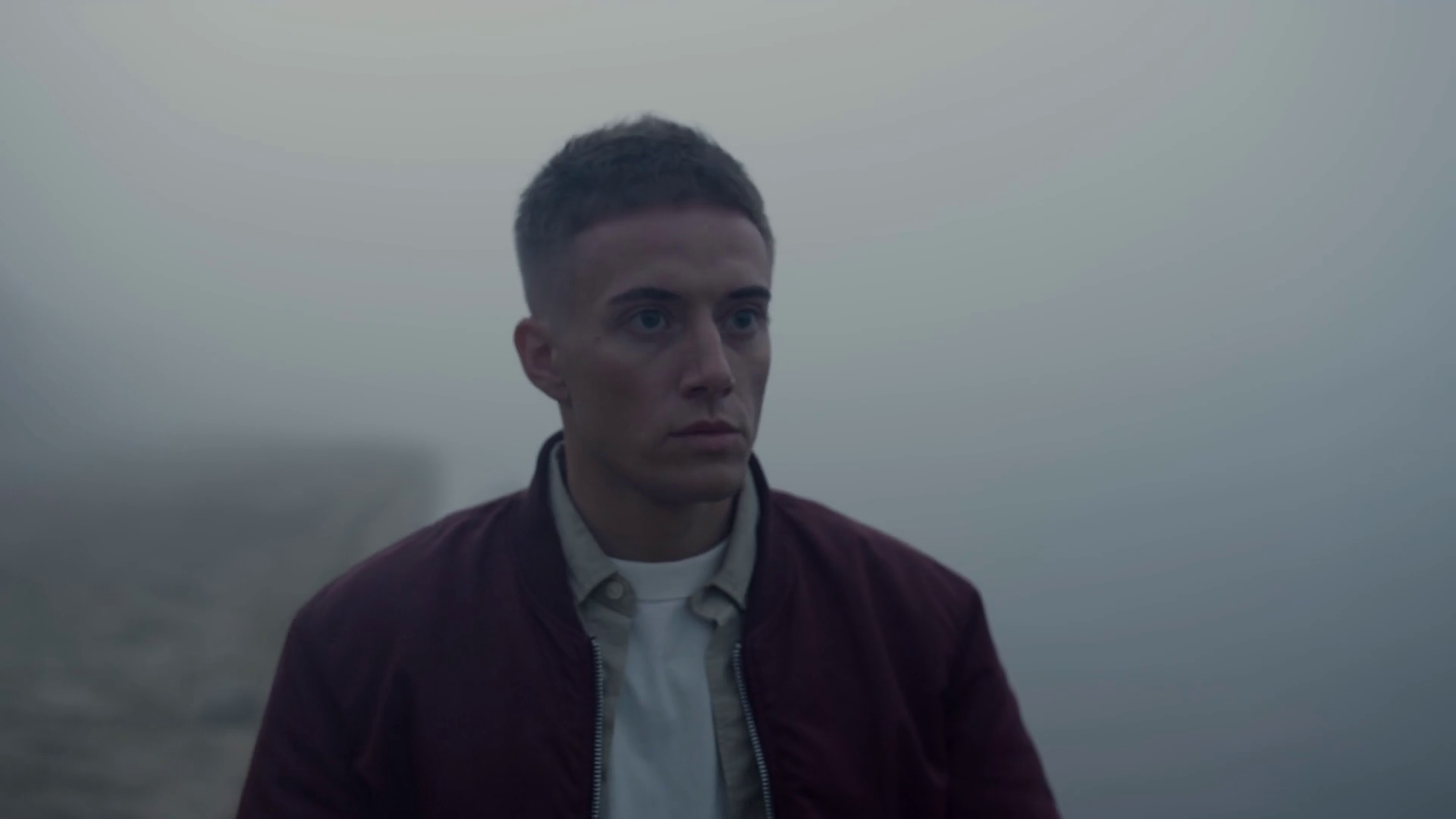 Portrait of depressed man looking ocean horizon in morning mist ...