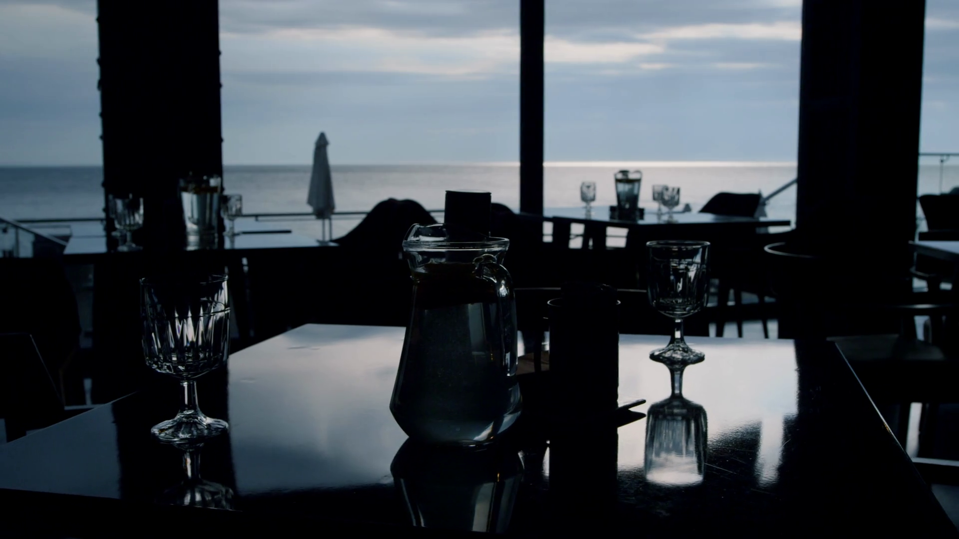 Evening sea view in stylish restaurant dining hall background. Served ...