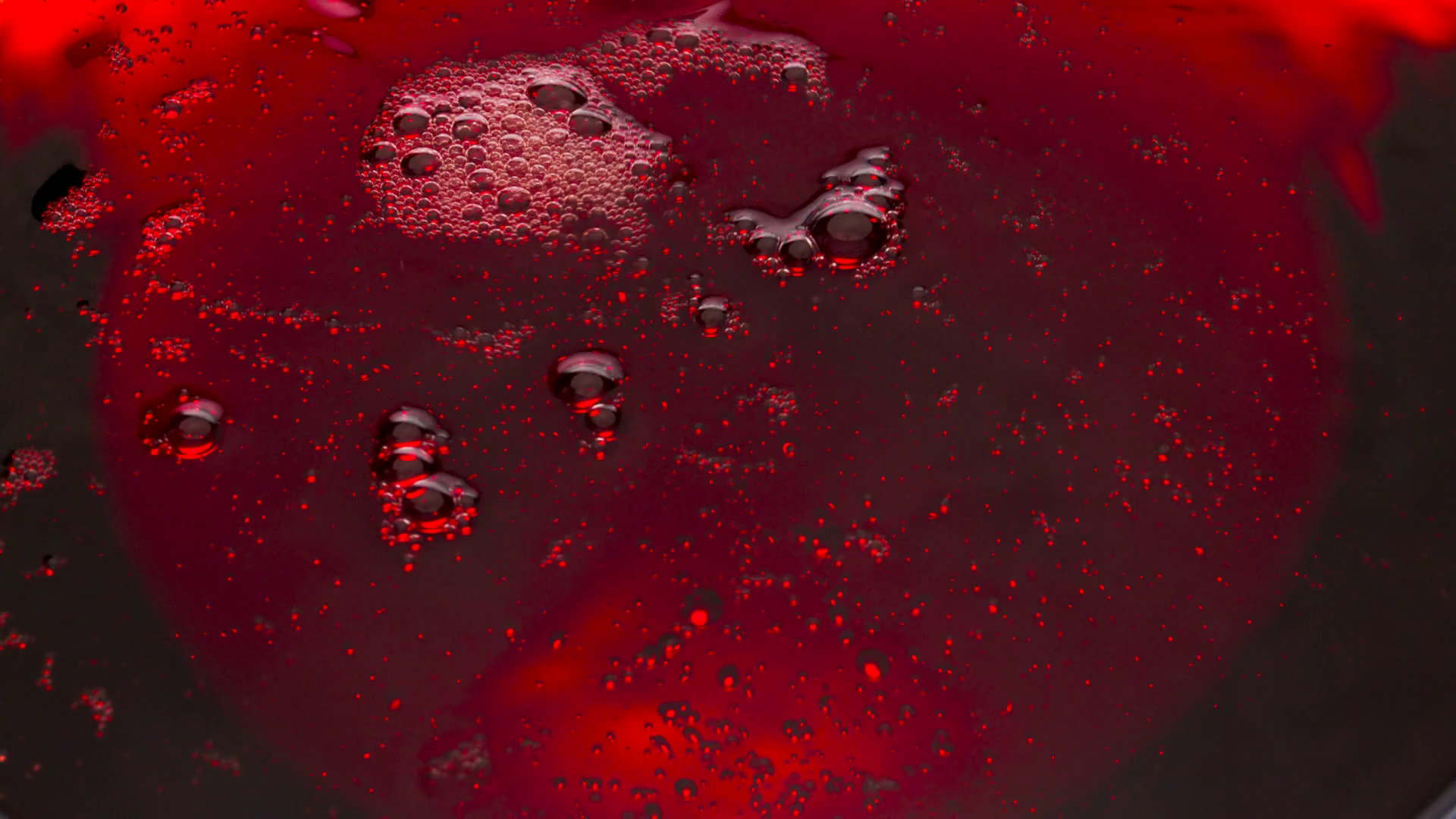 Red wine foamy texture closeup. Bubbled liquid surface frothing moving ...