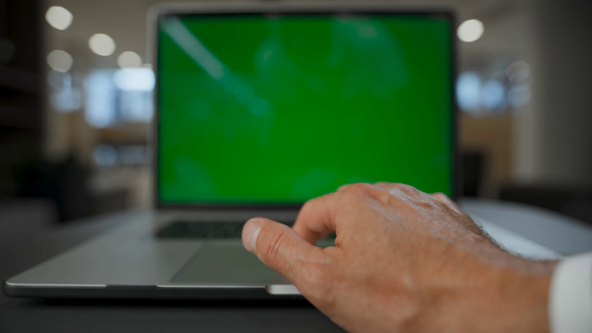 Unrecognizable man using touchpad at greenscreen device at lounge ...