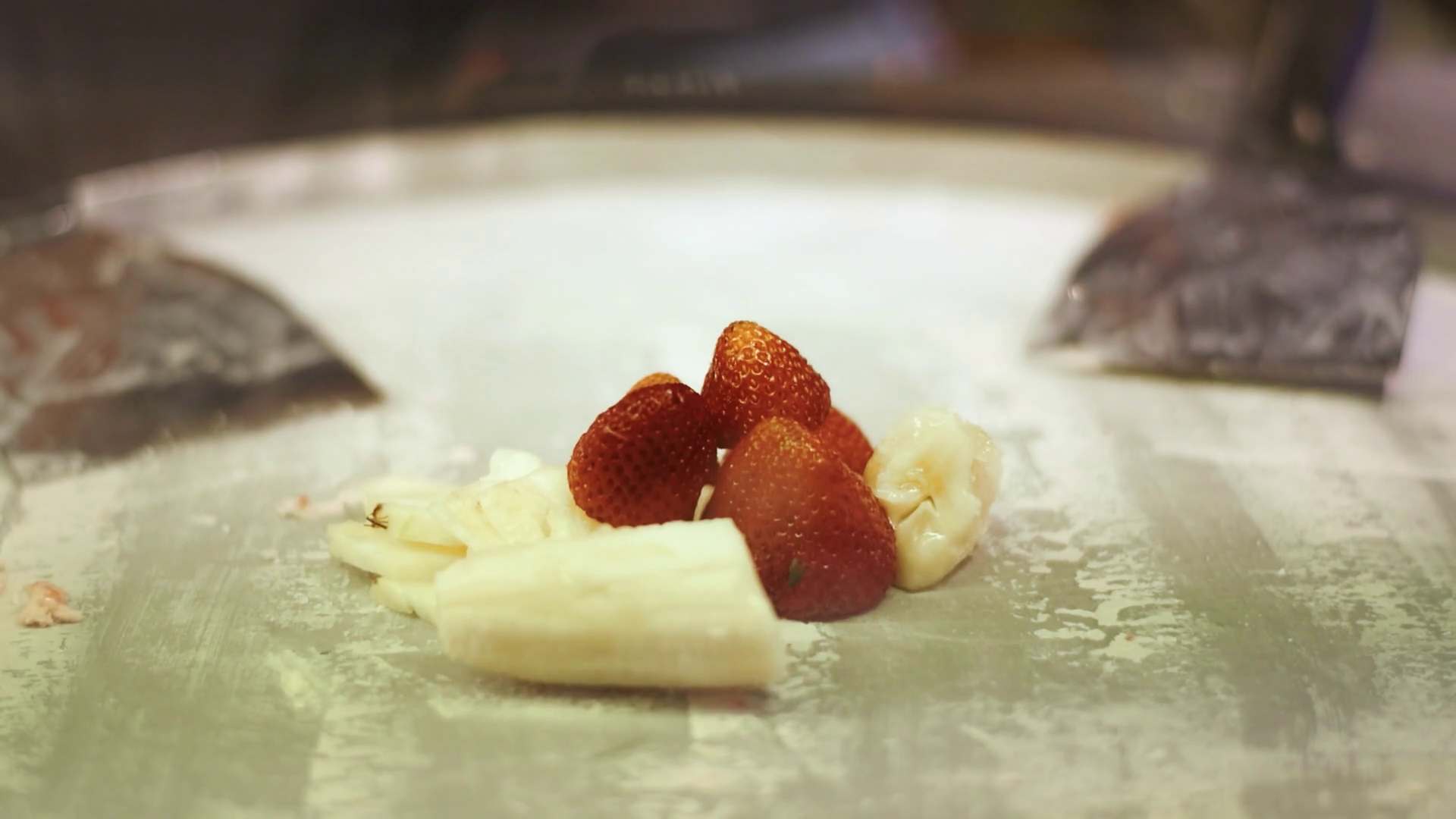 Chef pouring milk around fruits on freeze plate. Cooking process of ...