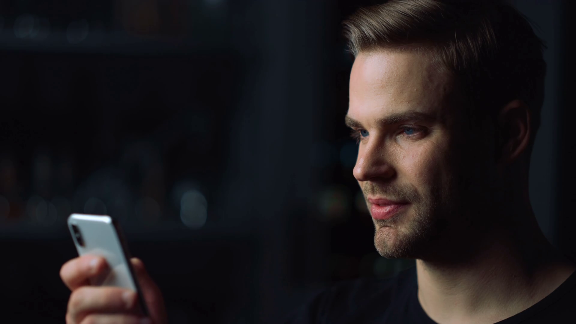Close up of handsome man using smartphone for watching video. Smiling ...