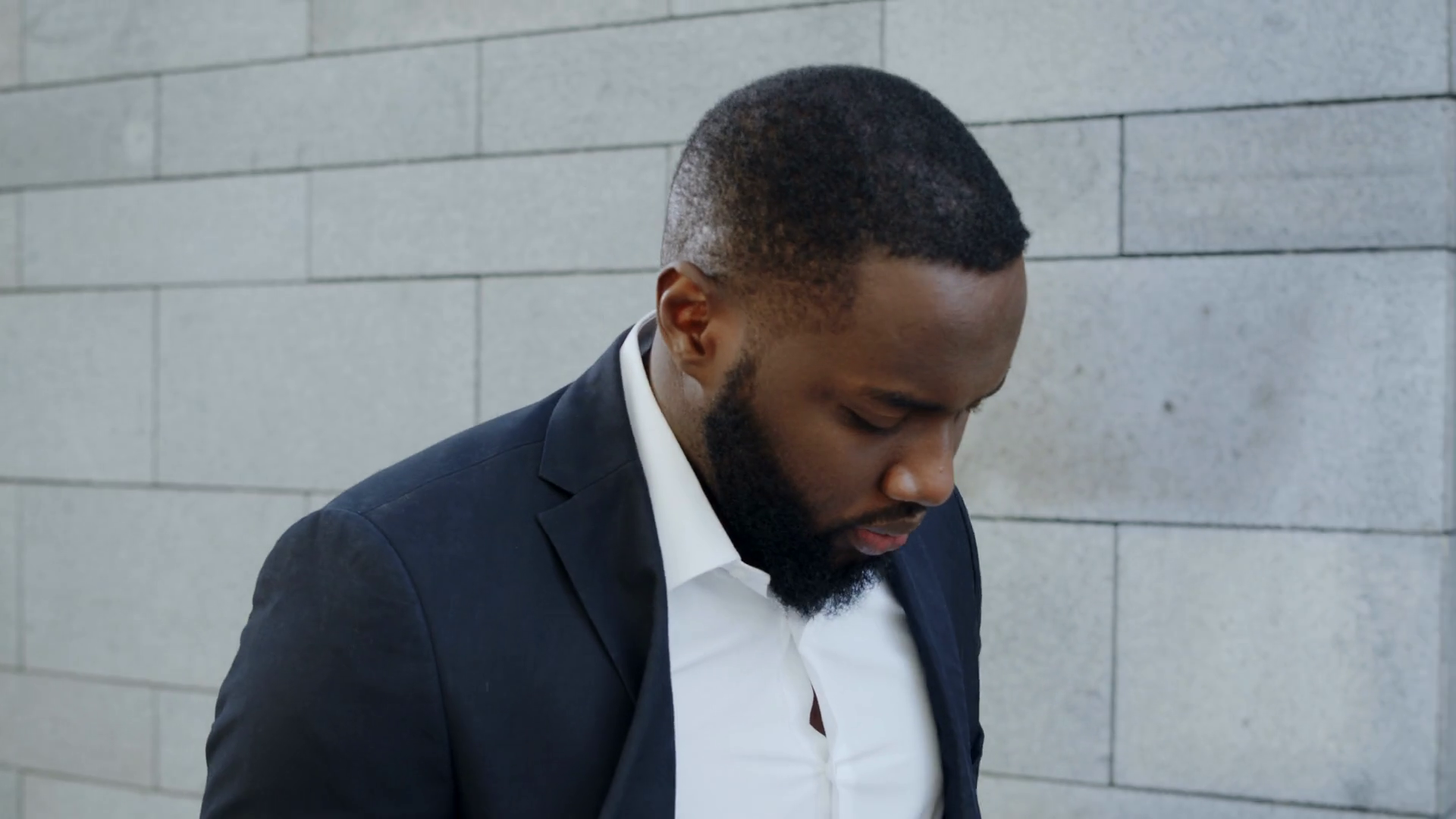 Closeup thoughtful businessman walking on city street. African american ...
