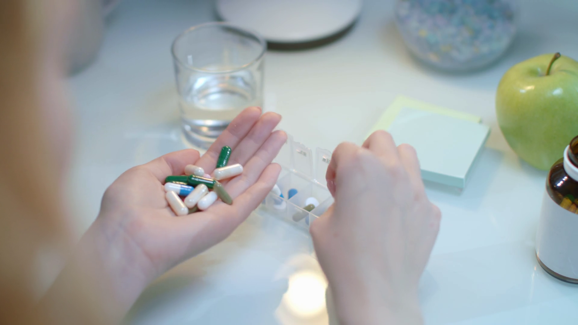 Doctor hand taking pills in pill dispenser. Close up of female hand ...