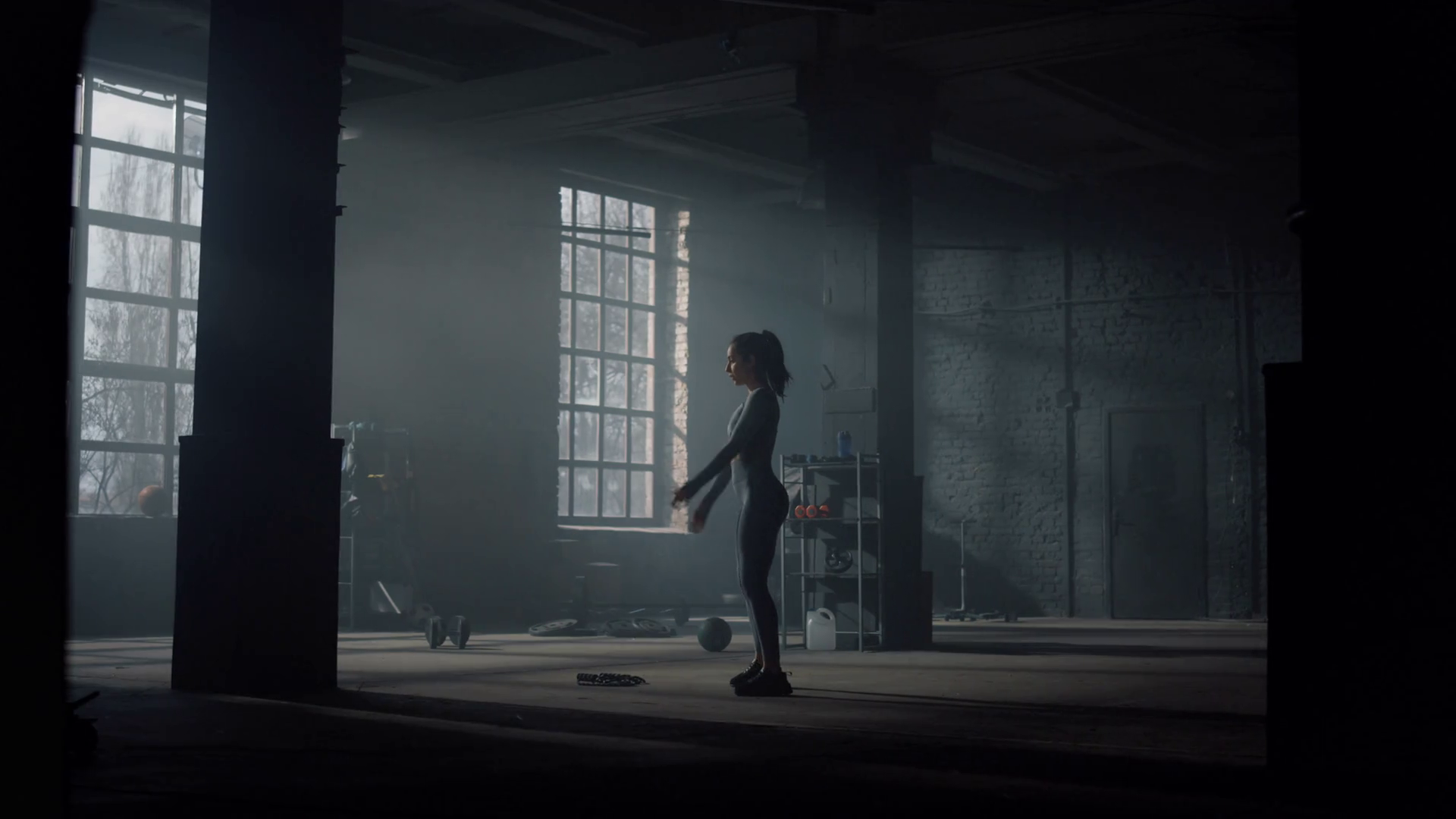 Female bodybuilder doing fitness exercise in loft building. Sportive ...