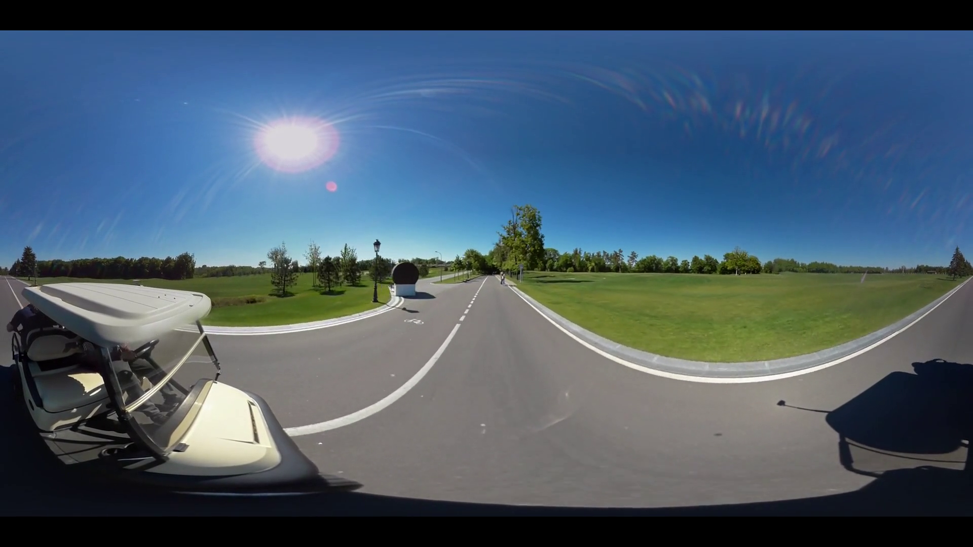 Golf cart moving on road along green field. Panoramic view golf cart ...