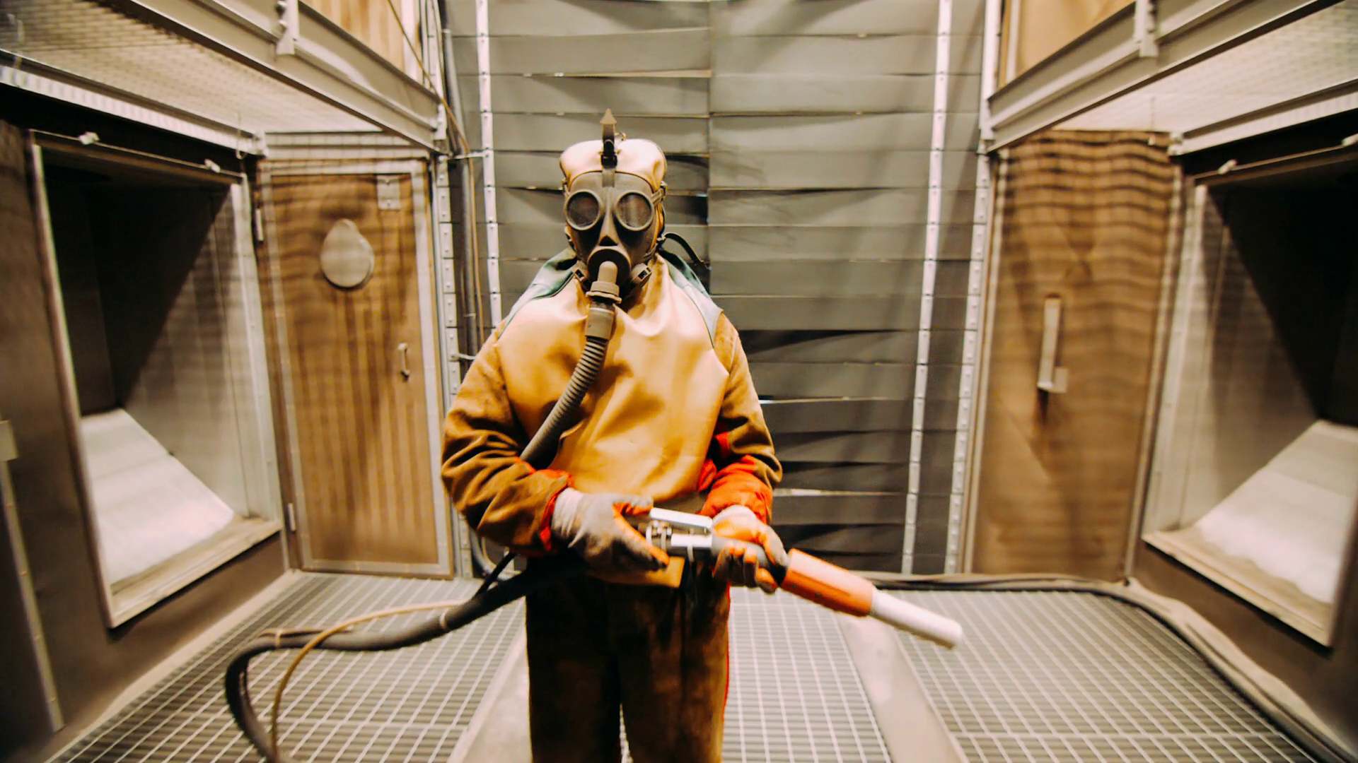 Man in protective suit with gas mask and hose in hands. Pest control ...