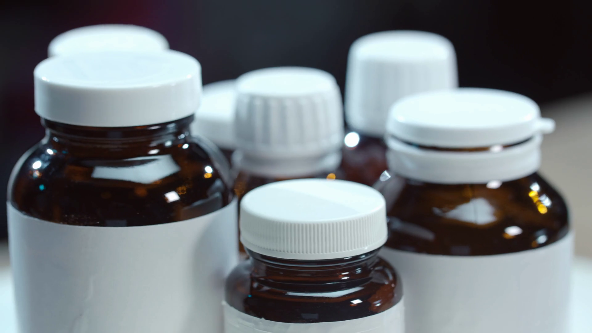 Medical bottles rotating on table. Pharmaceutical bottles for liquid ...