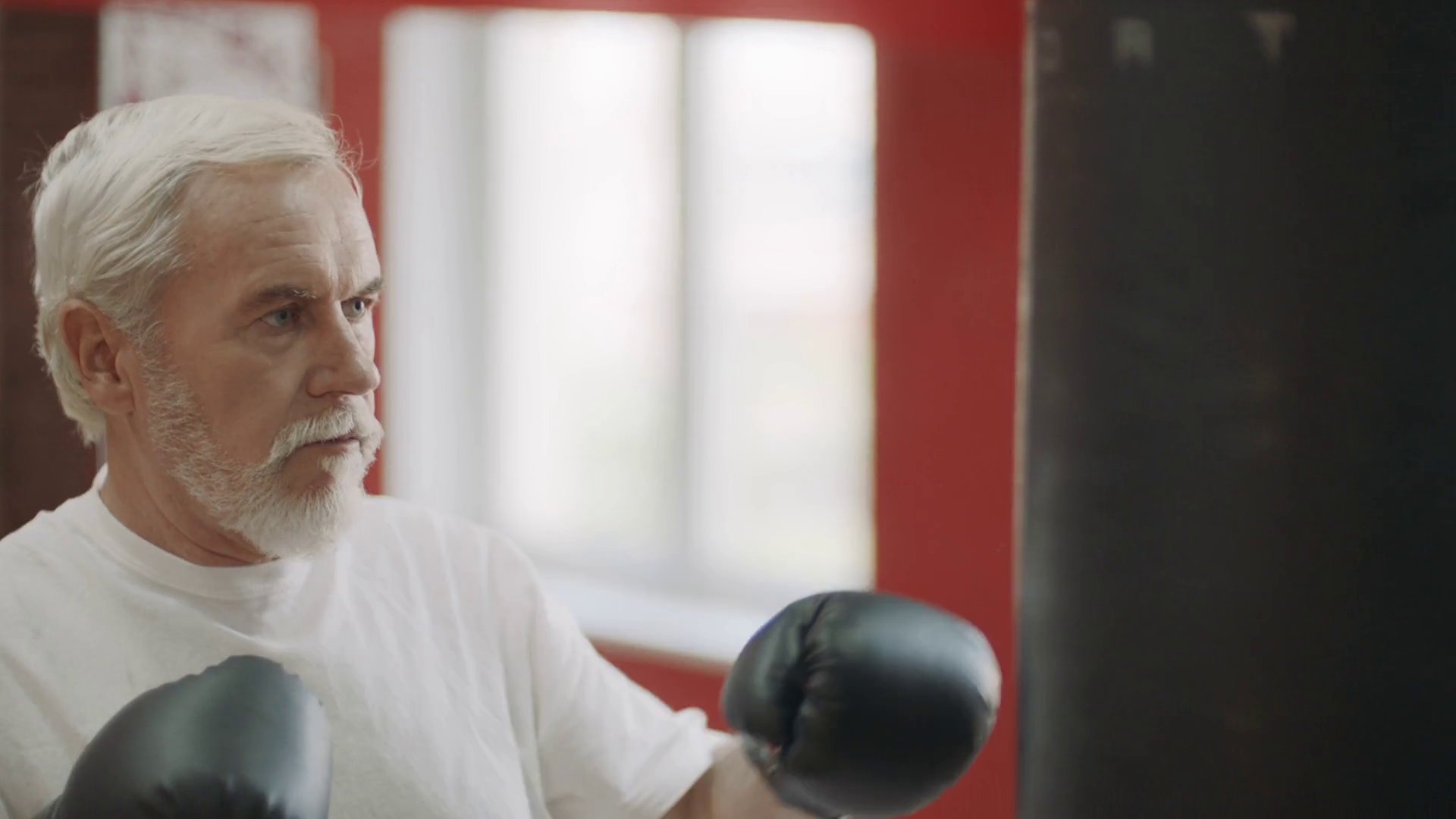 Elderly Man Training Kick On Boxing Bag At Stock Footage SBV-337169476 ...