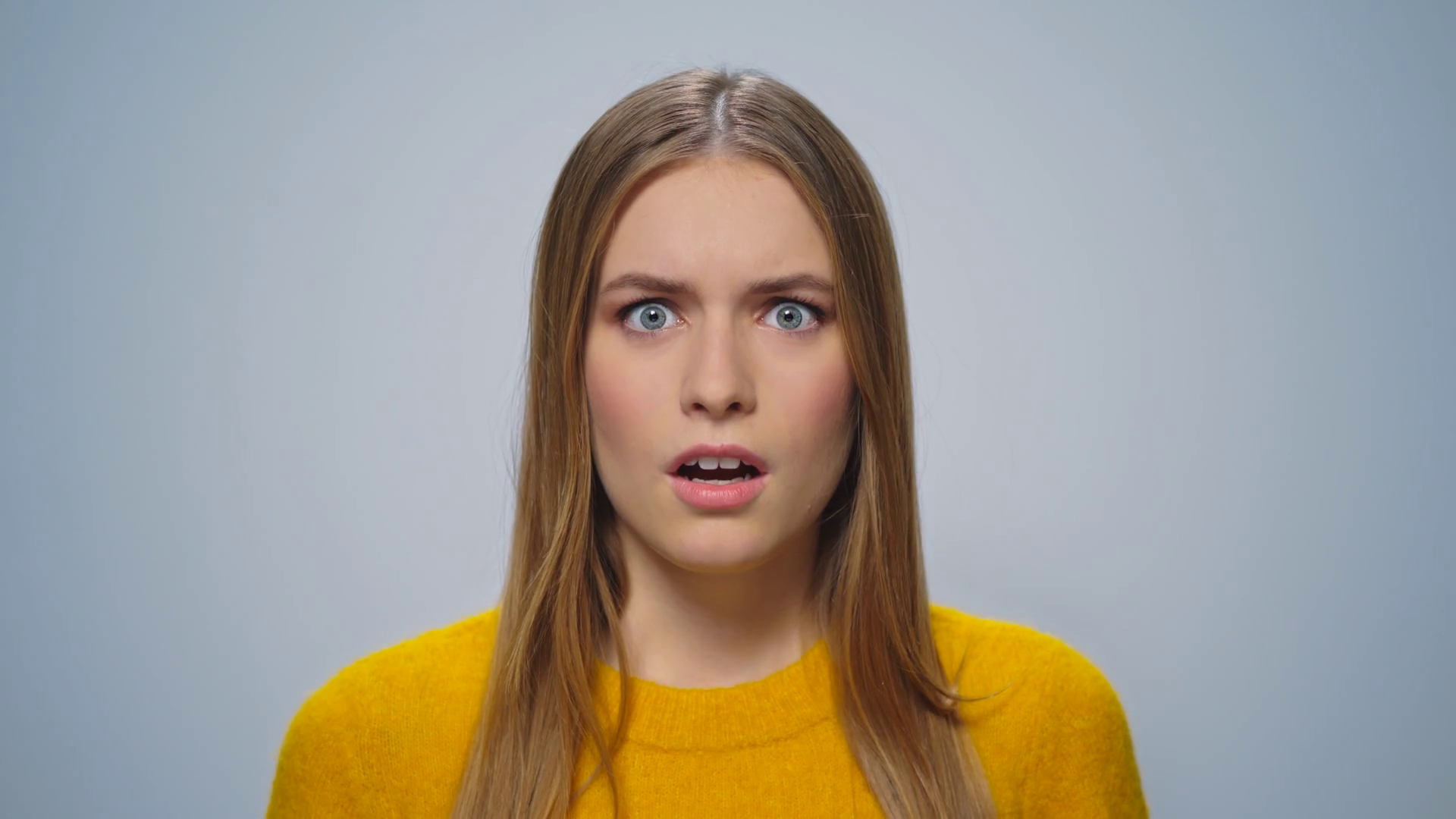 Portrait of scared girl looking on grey background. Closeup ...