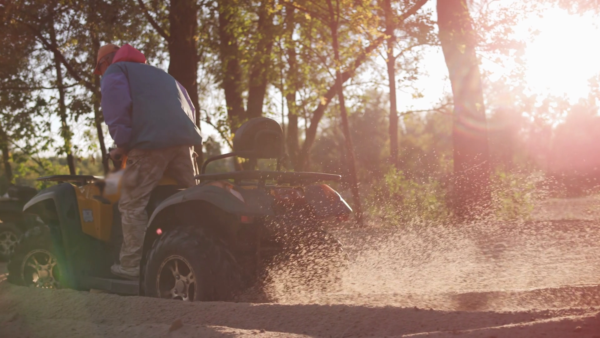 Quad bike start in slow motion. Man on atv starting with dust at sand ...
