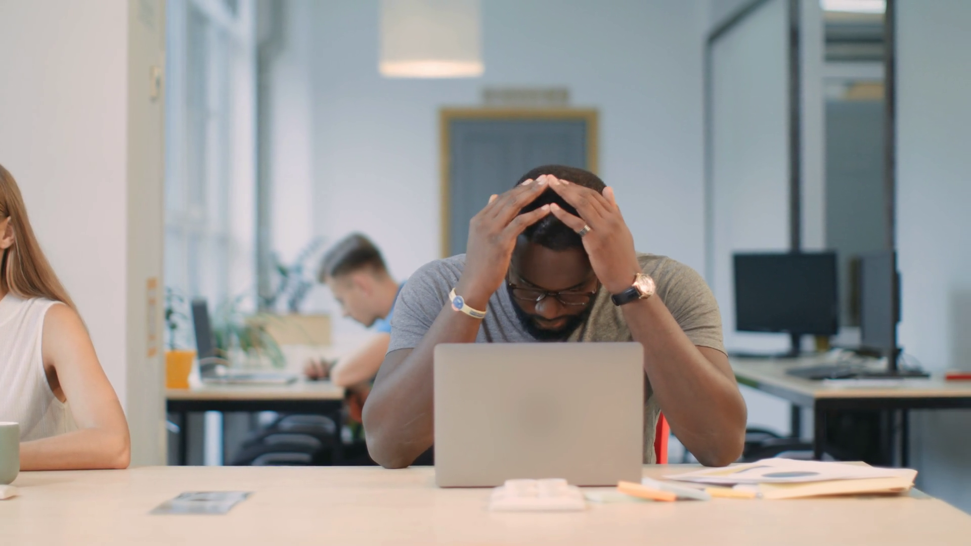 Upset man reading bad news on laptop computer at coworking space ...