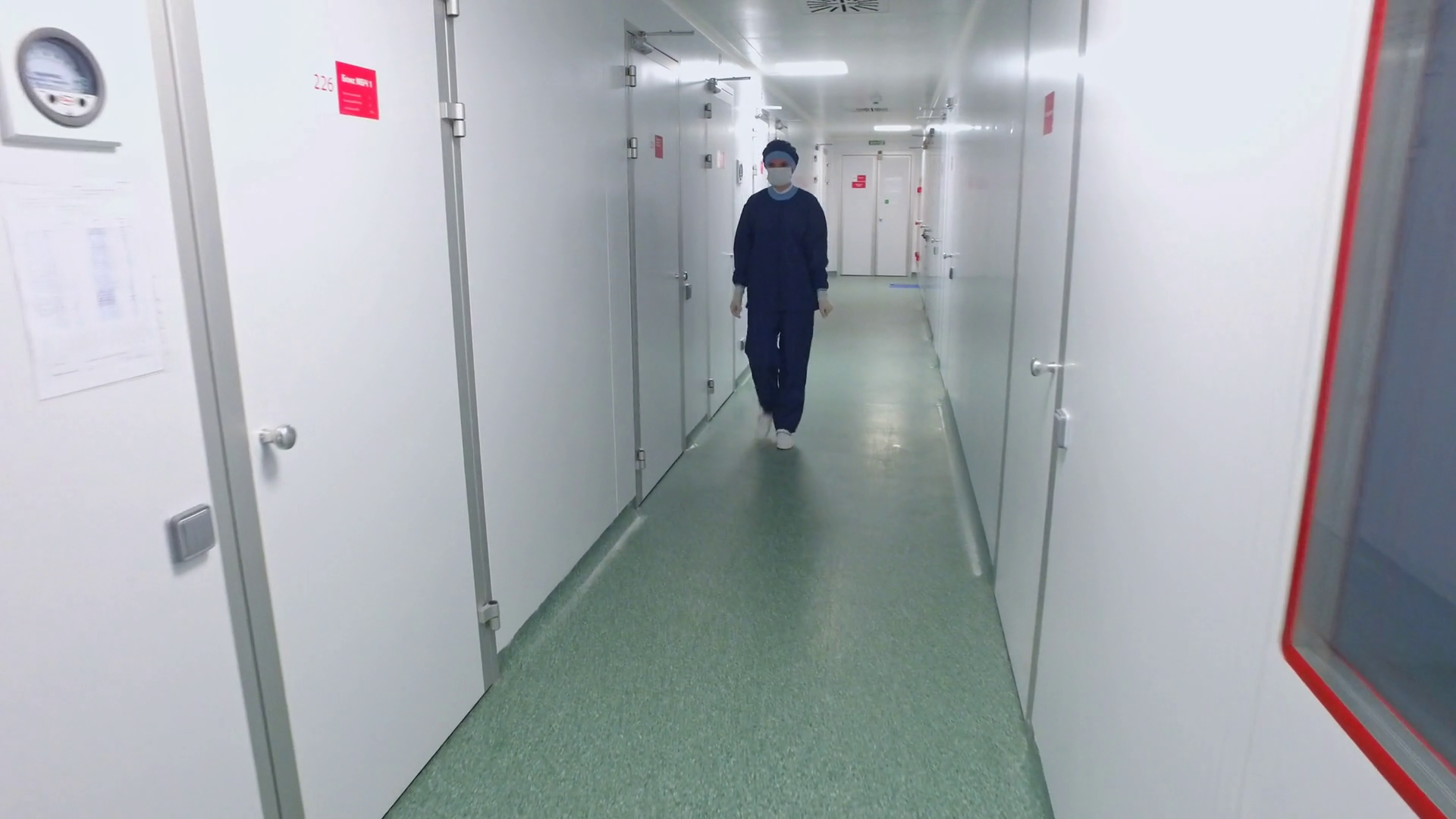 Walking through laboratory corridor. Female worker going chemical lab ...