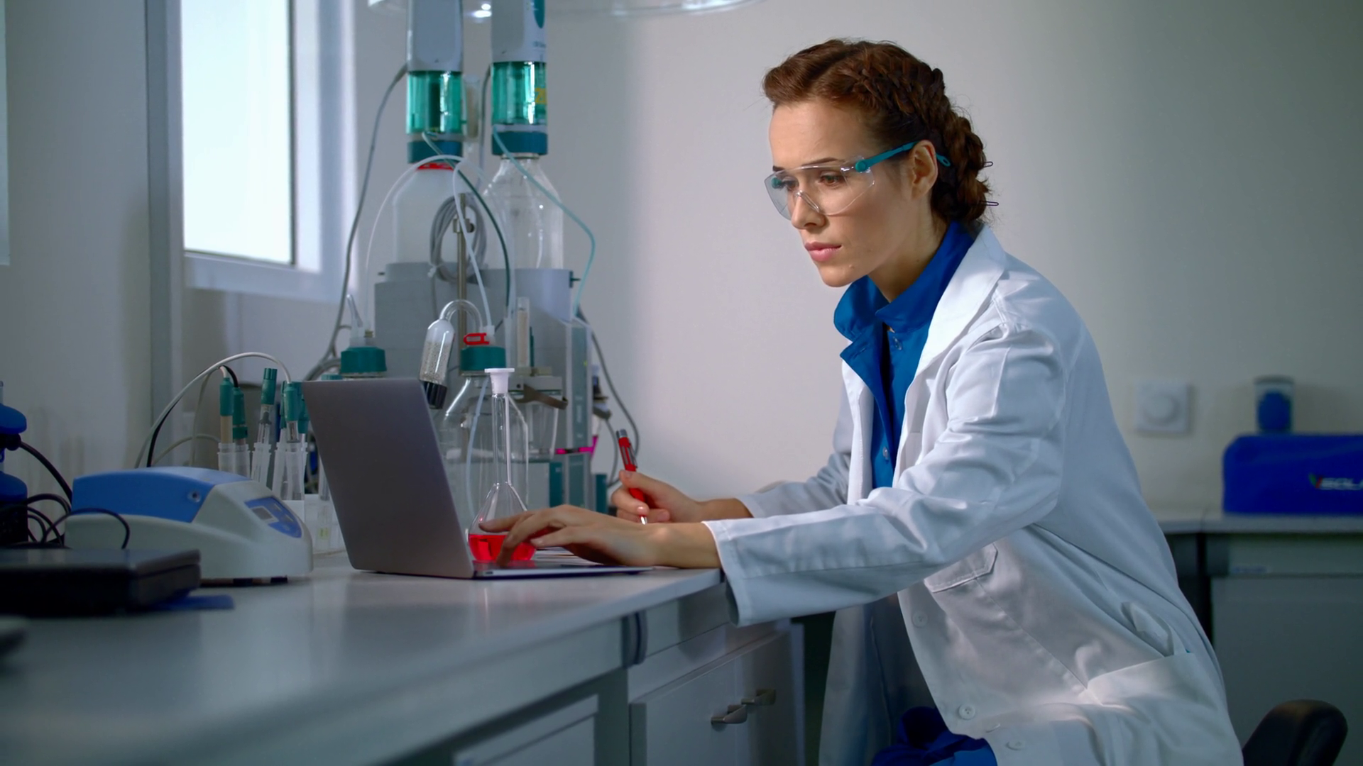 Young scientist writing down results of research. Laboratory scientist ...