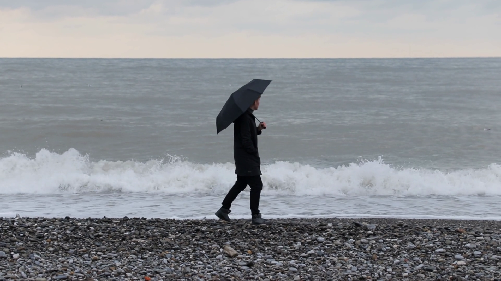 Man Walking On Beach With Umbrella In Rain Stock Footage SBV-346417942 ...