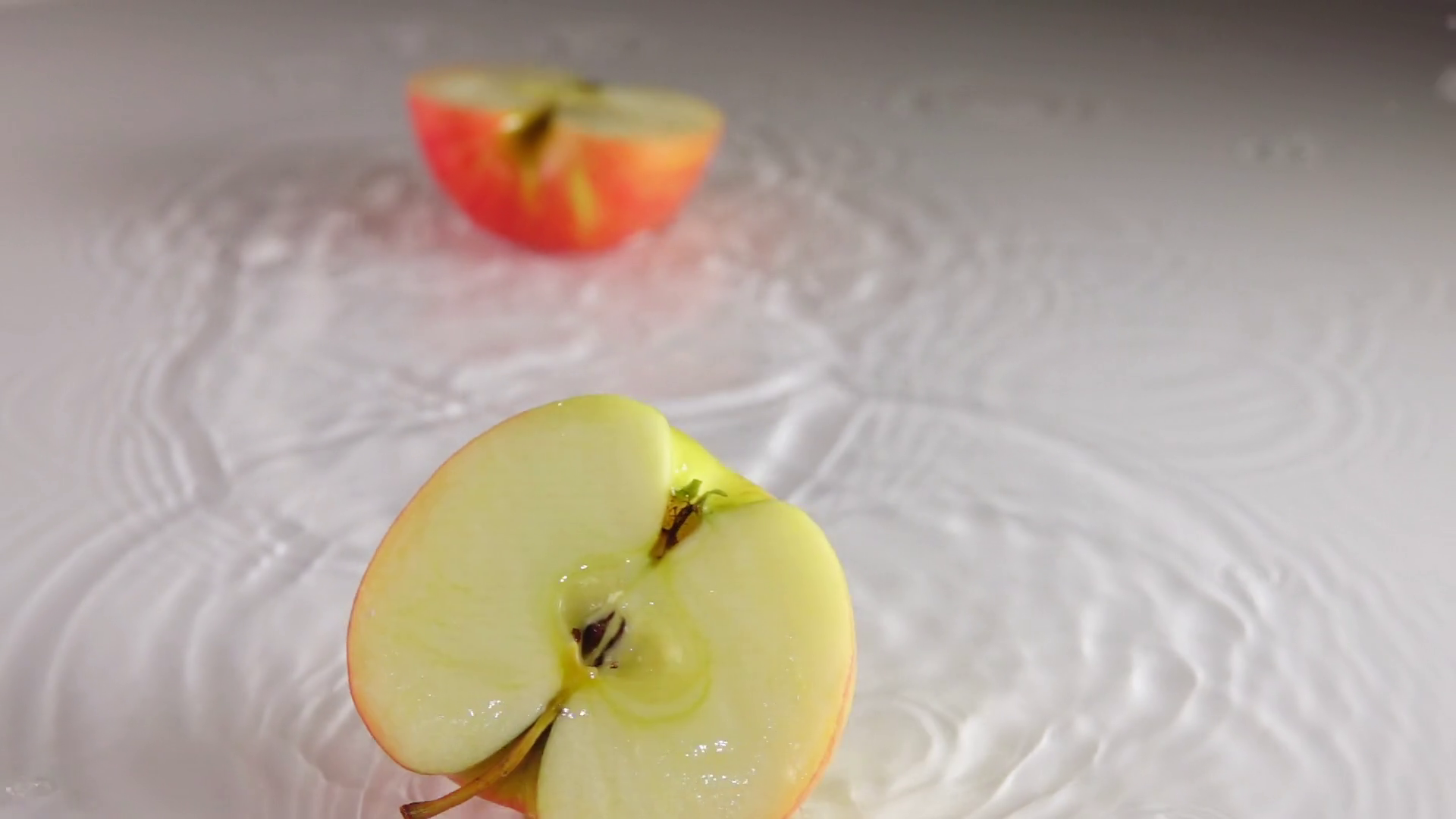 Apple Falls To Water Surface Splits In Half Stock Footage SBV-348383114 ...