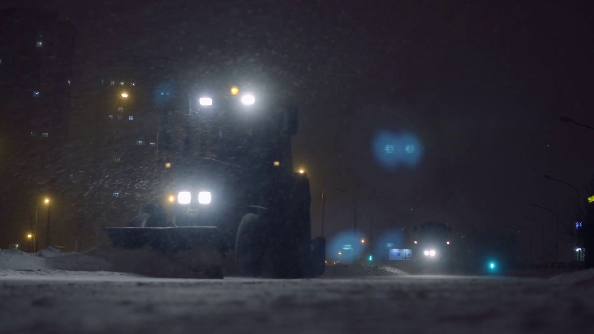 At night in a snowfall, the equipment removes snow. Snow removal ...