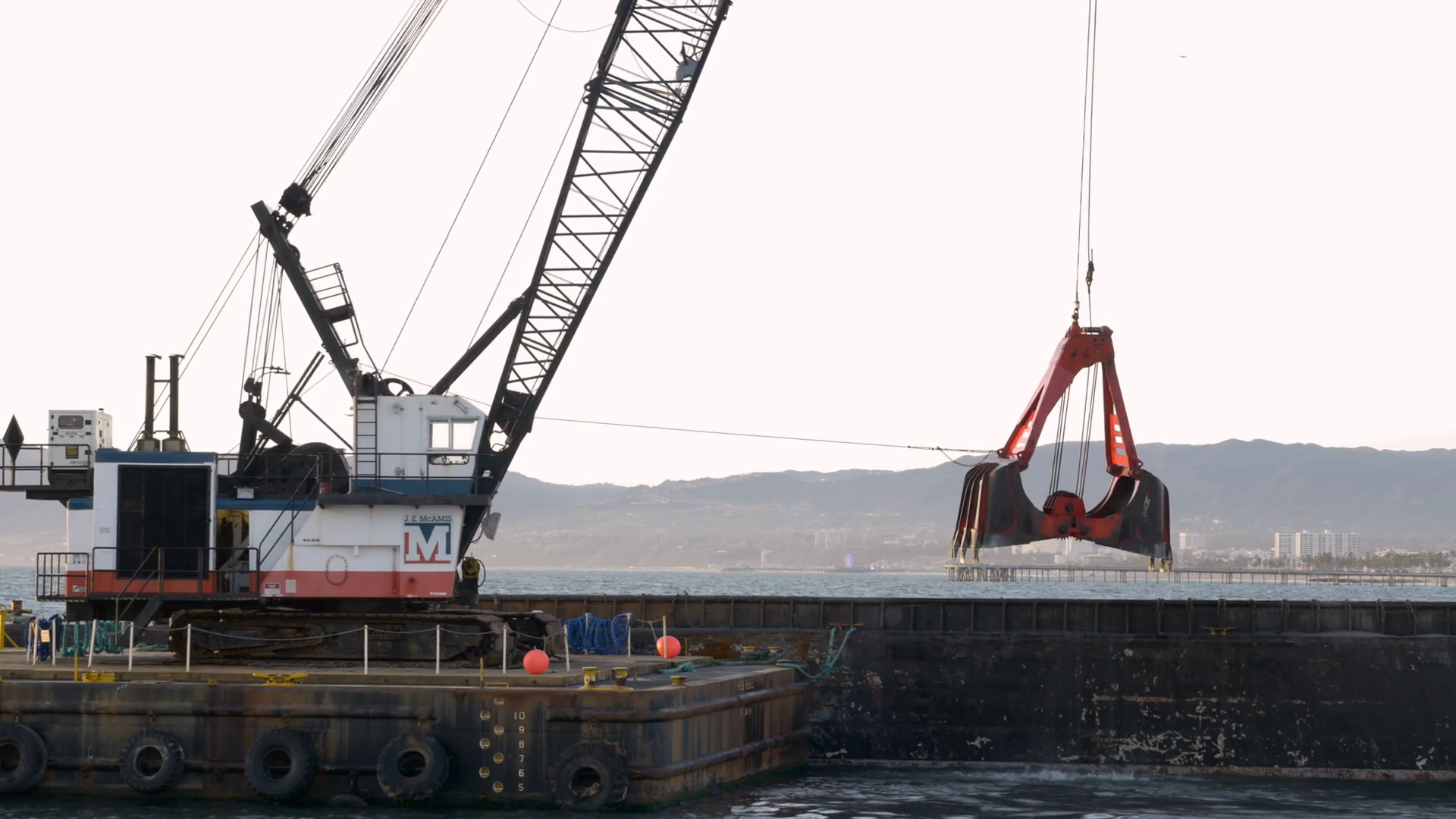 Dredger ship digging sand out of ocean floor on to a barge Stock Video ...