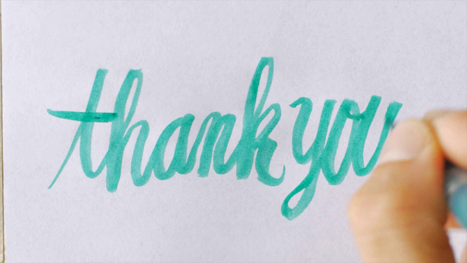 Hand Writing The Words THANK YOU In Cursive And Underlining Them With A