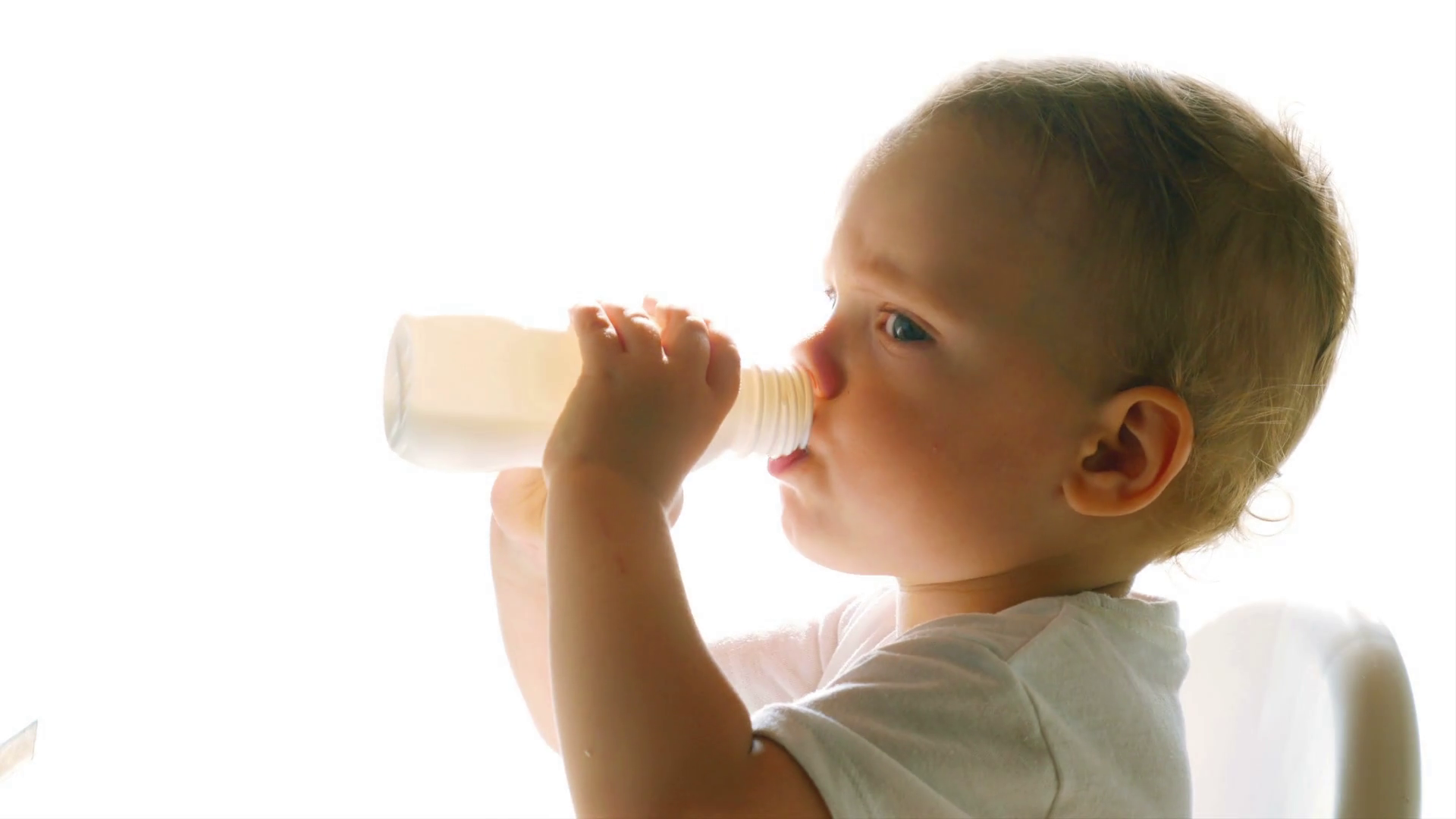 Boy Drinking Milk From The Bottle On White Background Stock Video