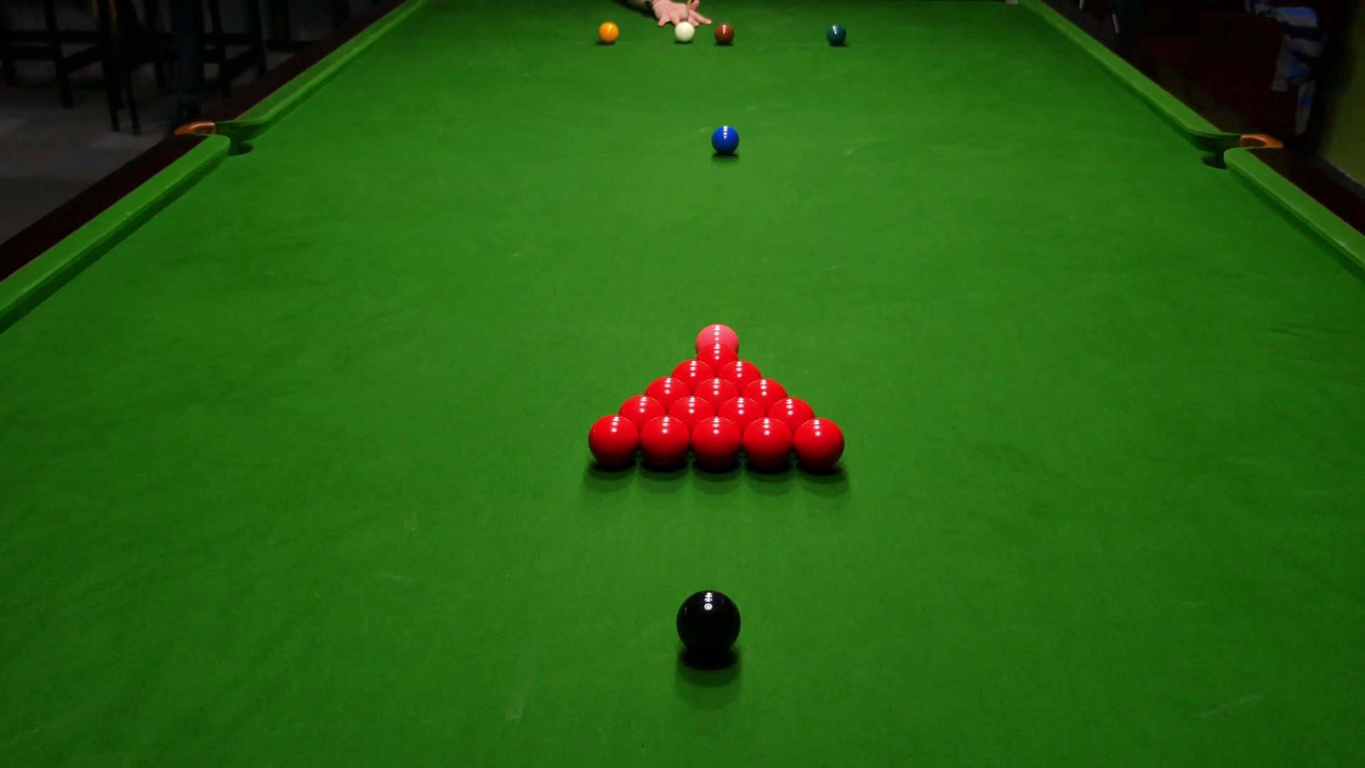 High angle shot of a snooker player breaking the balls at a snooker ...