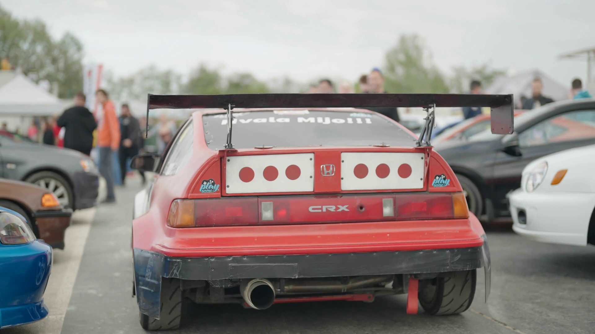 KRSKO, SLOVENIA - OCTOBER 2022: Tuned Honda CRX racing car with big spoiler tracking from rear ...