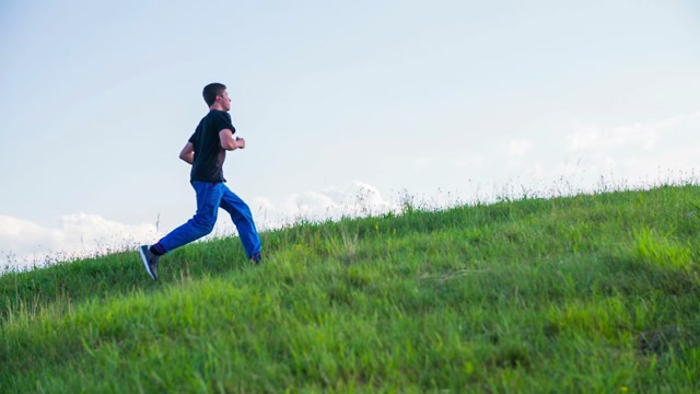 Man Runnign A Grass Field Stock Footage: Royalty-Free Video Clips ...
