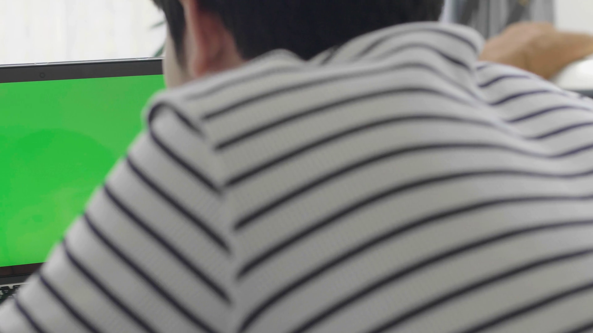 Over the shoulder shot of Asian boy looking at green screen. Home ...