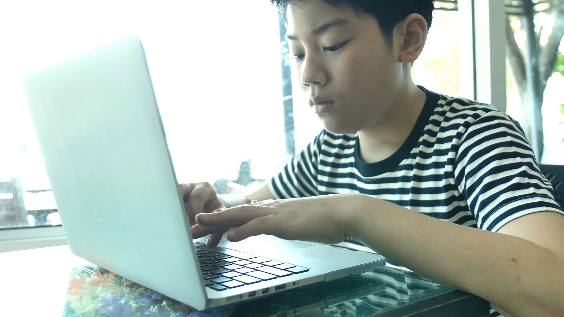 Slow motion 4K happy asian boy typing on laptop computer. Stock Video ...