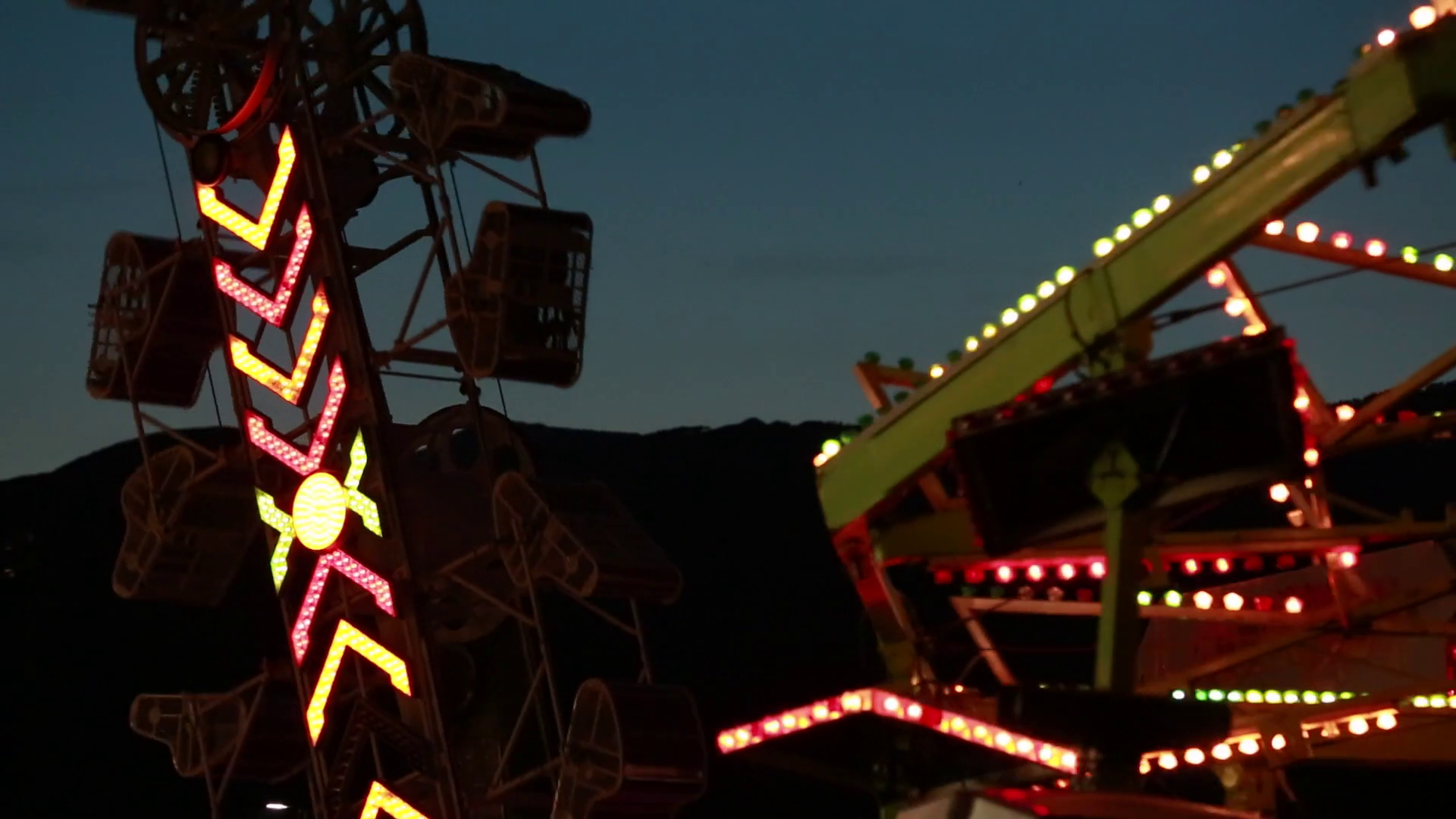 carnival rides at night time with flashing lights Stock Video Footage ...