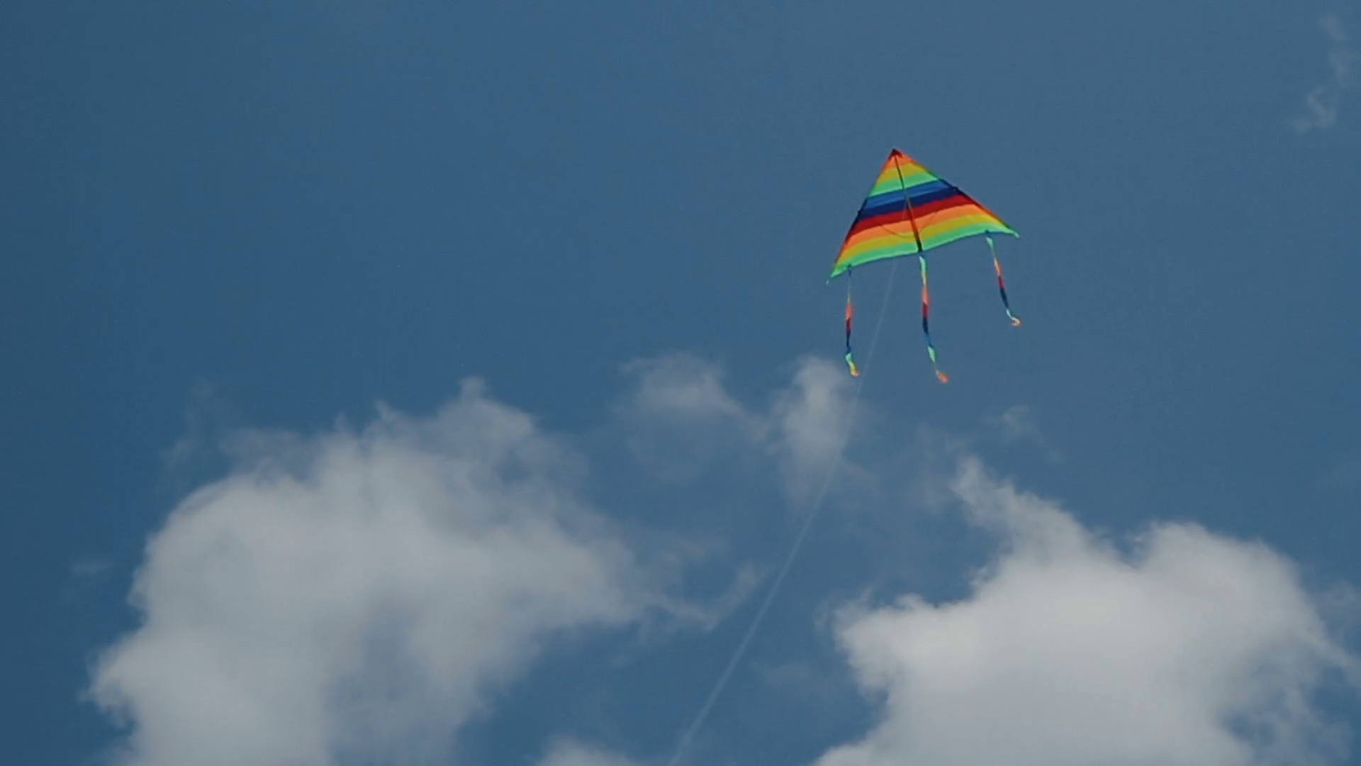 Colorful kite floating in the air on a blue sky background Stock Video ...