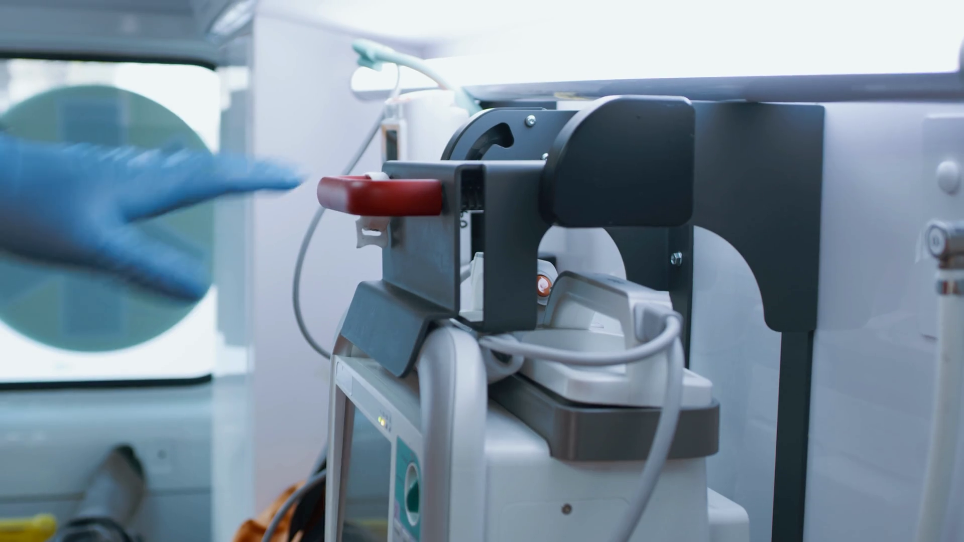Tilt down view of diverse paramedics taking defibrillator paddles and ...